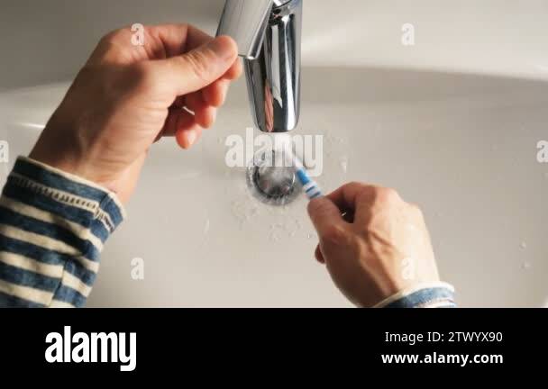 Squeezing toothpaste from a tube on a toothbrush Stock Video Footage ...