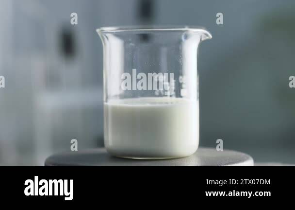 Laboratory experiments. Milk testing in glass. Reagent and milk mixing ...