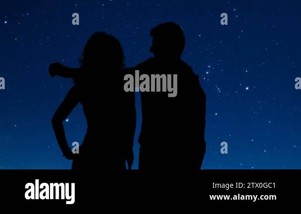 Loving couple shadow hugging and looking at stars in night sky ...