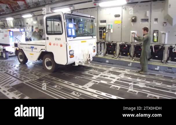 Ground support vehicles of the US coast guard entering a hangar Stock ...