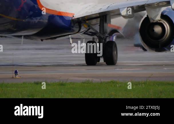 Landing gear of Boeing 777. Aircraft turns on taxiway. Jet engine makes ...