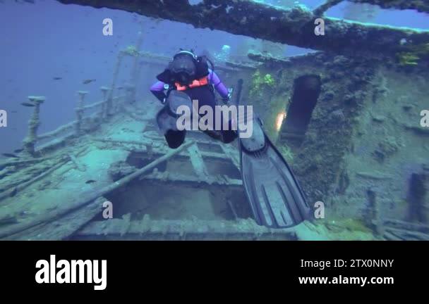 Scuba Diver Exploring A Large Shipwreck. Scuba Diving Inside The ...