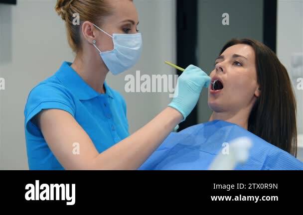 Woman Patient With Open Mouth During Oral Checkup In Dental Clinic ...