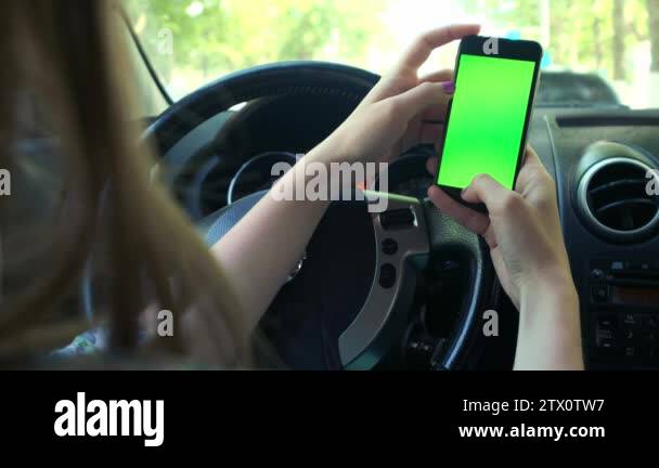 Girl Driver closeup, greenscreen in the car, urban city background ...