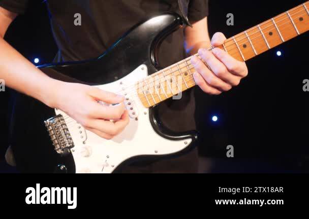 Concert rock band performing on stage with two electric guitars singers ...