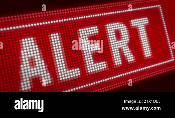 Alert word on big LED display with large pixels. Bright light warning ...