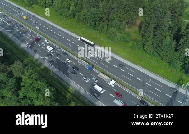 AERIAL: Countless cars and trucks moving through a bottleneck forming ...