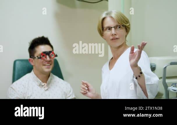 young man at a reception with an ophthalmologist, checks vision, having ...
