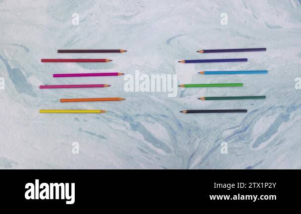 Wooden school pencils of different colors moving on blue background ...