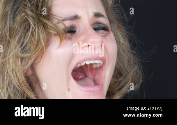 Beautiful young tearful unhappy woman crying washing off makeup. Real ...