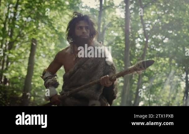 Portrait of Primeval Caveman Wearing Animal Skin and Fur Hunting with a ...