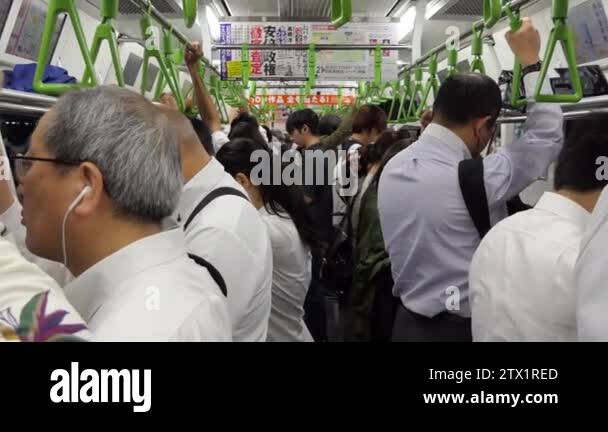 TOKYO / JAPAN - JULY 2019: Japanese people commuting on local train ...