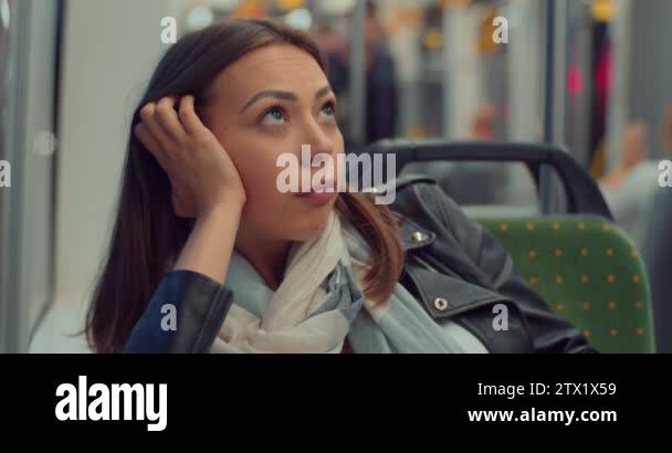 Portrait of sad young girl ride in public transport in night. Traffic ...