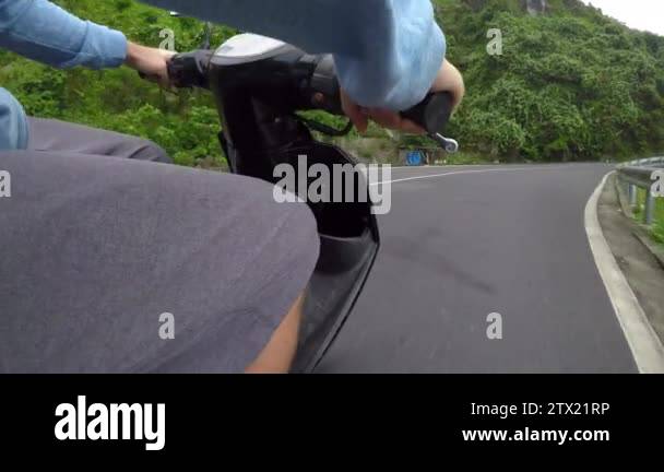 CLOSE UP: Unrecognizable male tourist riding a motorcycle across the ...