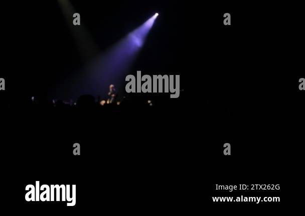 The singer sings on stage, it is lit by spotlights Stock Video Footage ...