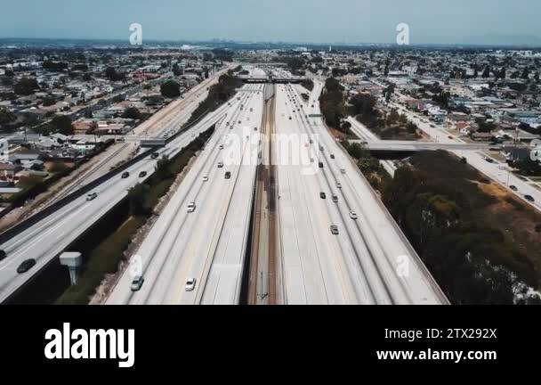 Drone flying forward over large busy American interstate highway with ...