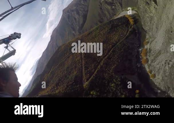 SELFIE: Cheerful young man goes bungee jumping in breathtaking sunny ...