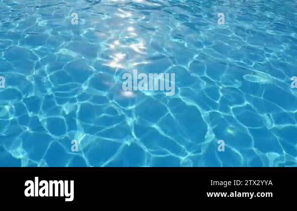 Turquoise swimming pool background shining with its see-through waves ...