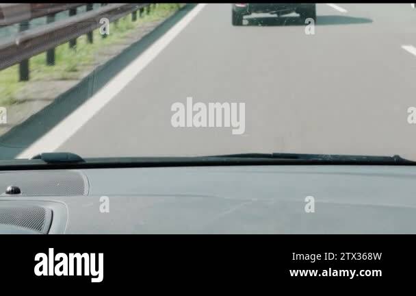 Car driving following at discreet distance in traffic on highway ...