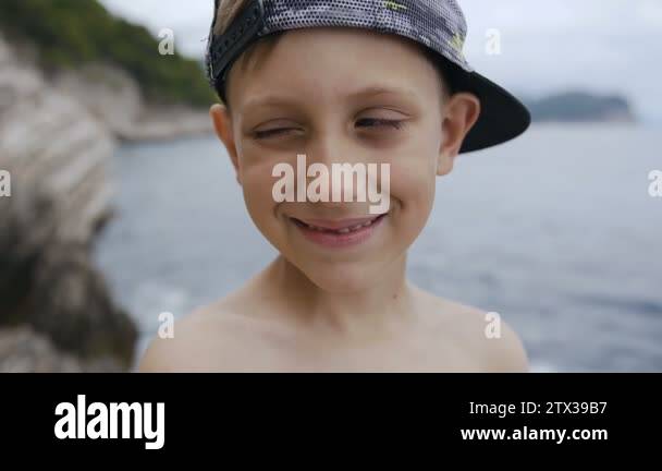 Attractive little boy with blue eyes looking at camera. Close-up of a ...