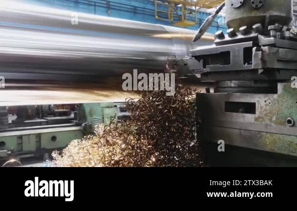 Close up of a CNC machine threading a steel roll. Twisted chips come ...