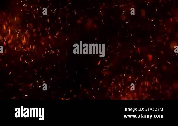 Burning red hot sparks fly from large fire in the night sky. Beautiful ...