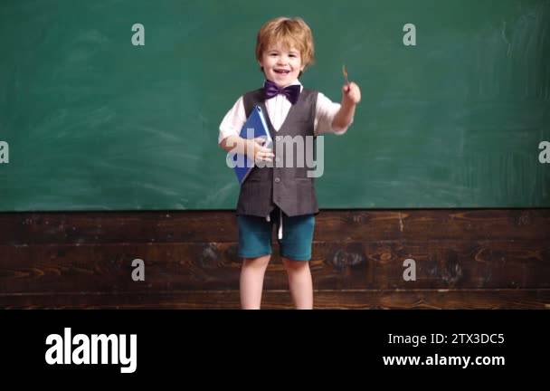 School kids against green chalkboard. Blackboard background ...