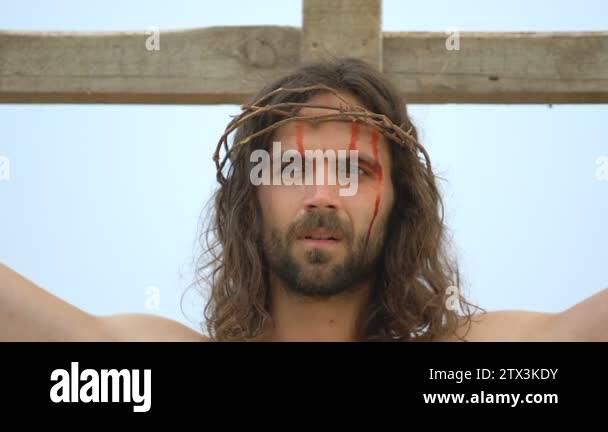 Crucified Jesus in thorn crown praying God Father in sky, atoning ...