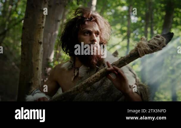 Portrait of Primeval Caveman Wearing Animal Skin and Fur Hunting with a ...