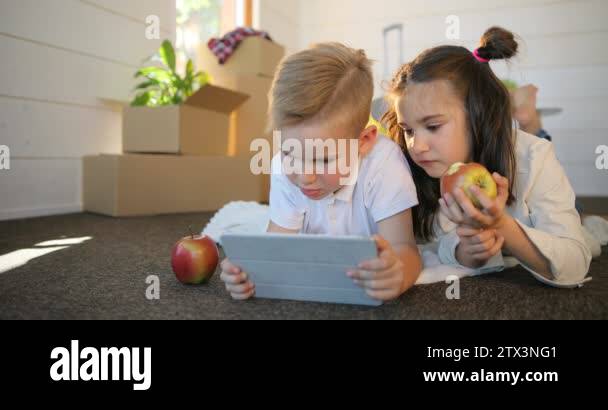 Happy siblings child playing with pc tablet together. Brother and ...
