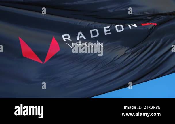 AMD Radeon Vega brand flag waving in slow motion against blue sky ...