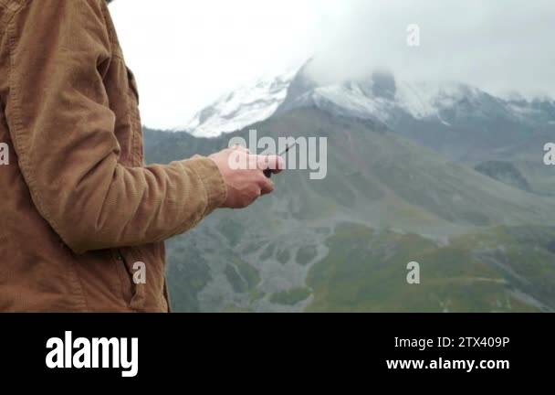 A male traveler blogger controls a copter. Holds the remote control in ...