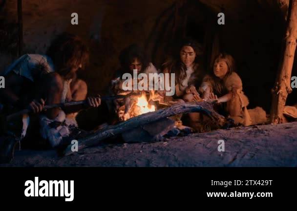 Neanderthal or Homo Sapiens Family Cooking Animal Meat over Bonfire and ...