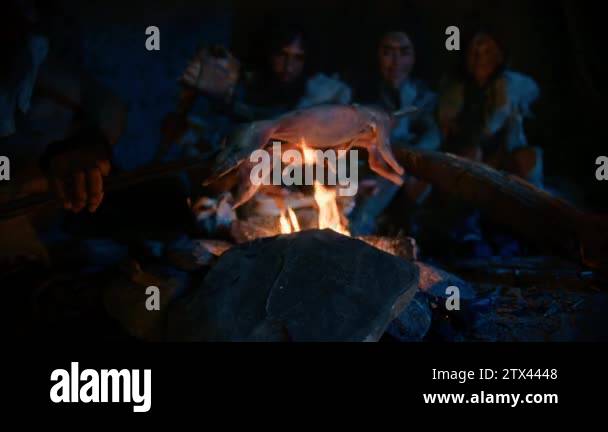 Neanderthal or Homo Sapiens Family Cooking Animal Meat over Bonfire and ...