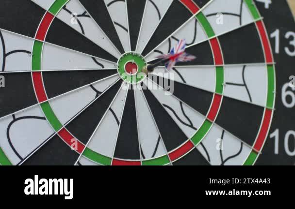 Three darts hitting the bullseye of the dartboard and one missing Stock ...
