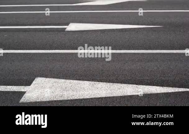 Cars crossing smooth road. One-way traffic. Cars in motion. Focus on ...