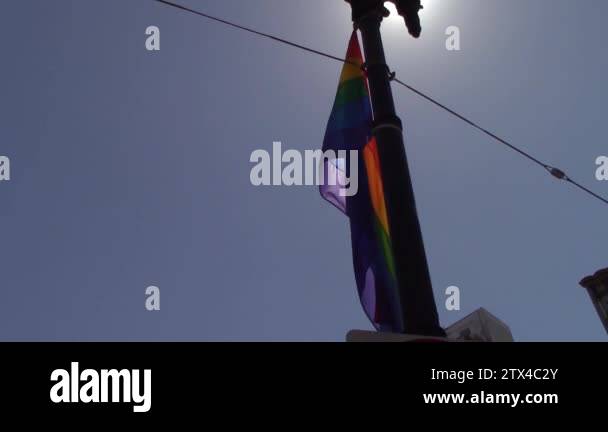 LGBT flag waving on lamp post during San Francisco's LGBT pride parade Stock Video Footage - Alamy