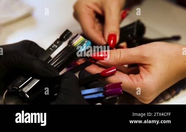 Manicure procedure. Female manicure procedure, selection of the color ...