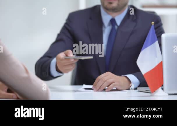 French consular officer giving passport to woman, refugee visa, asylum ...