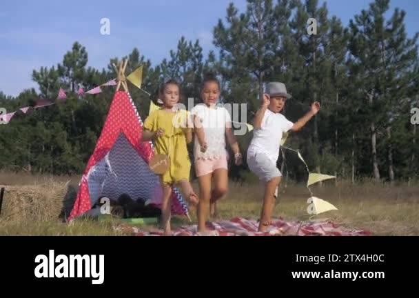 merry childhood, little beautiful girls and funny boy emotionally dance ...