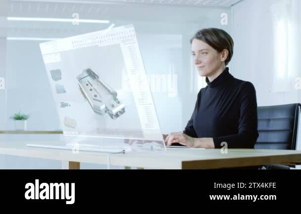 In the Near Future Beautiful Female Engineer Works on Her Computer with ...