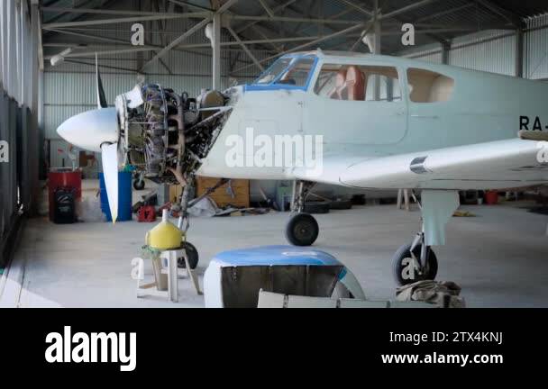 Plane standing in aircraft hangar, plane engine, repairing the plane ...