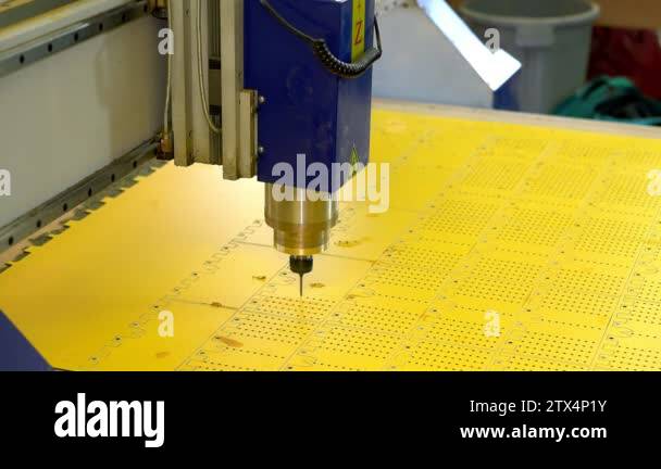 Close-up process of drilling holes in a plastic part on a CNC machine ...