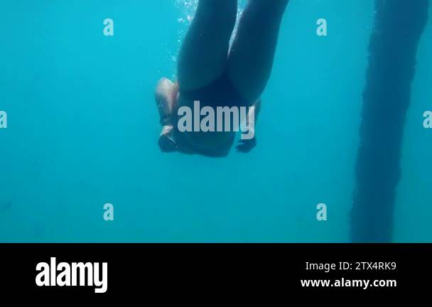 sea holiday, young sporty girl with beautiful booty diving spends her ...