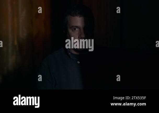 thief hidden in the darkness points the gun at the camera.Danger fear ...