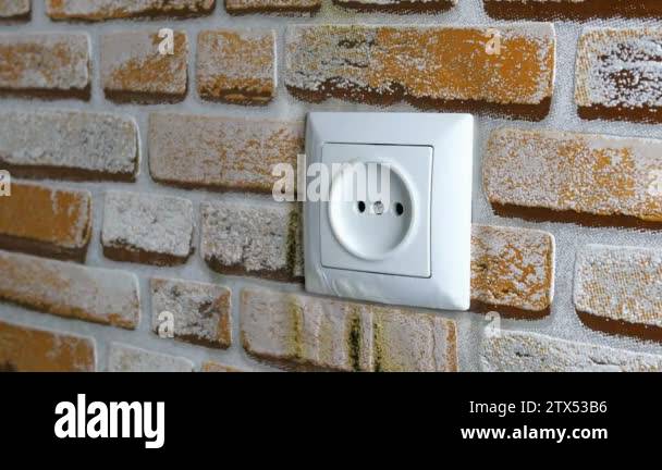 Electrical socket burns on wall in house. Short circuit and fire hazard ...