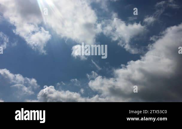 White clouds disappear in the hot sun on blue sky. Time-lapse motion ...