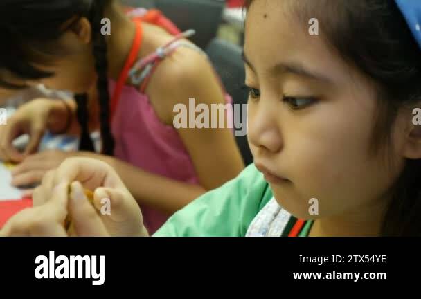 4K : Asian child learning to folding Japanese paper origami, art of ...