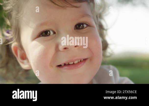SLOW MOTION, PORTRAIT, CLOSE UP, DOF: Curious small Caucasian girl ...