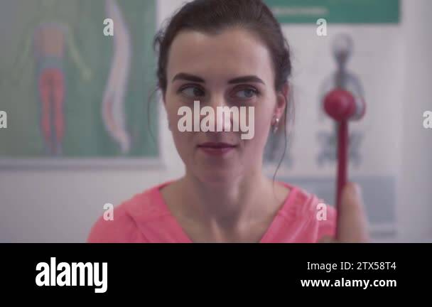 Doctor checking nerve reflexes of female with hammer. Doctor puts ...